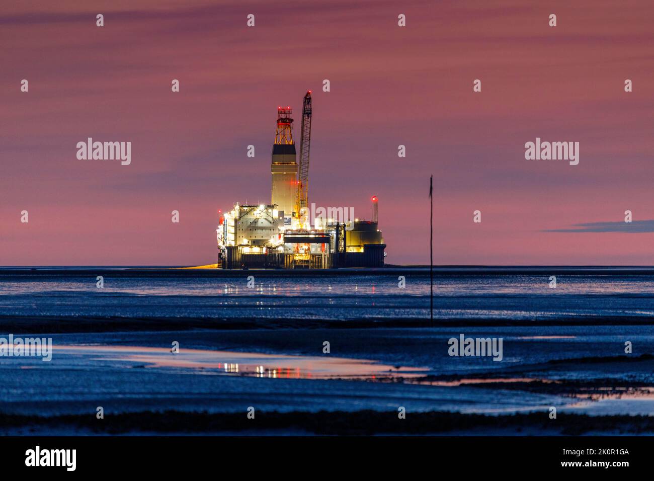 Germany's only oil rig "Mittelplate" at night Stock Photo - Alamy