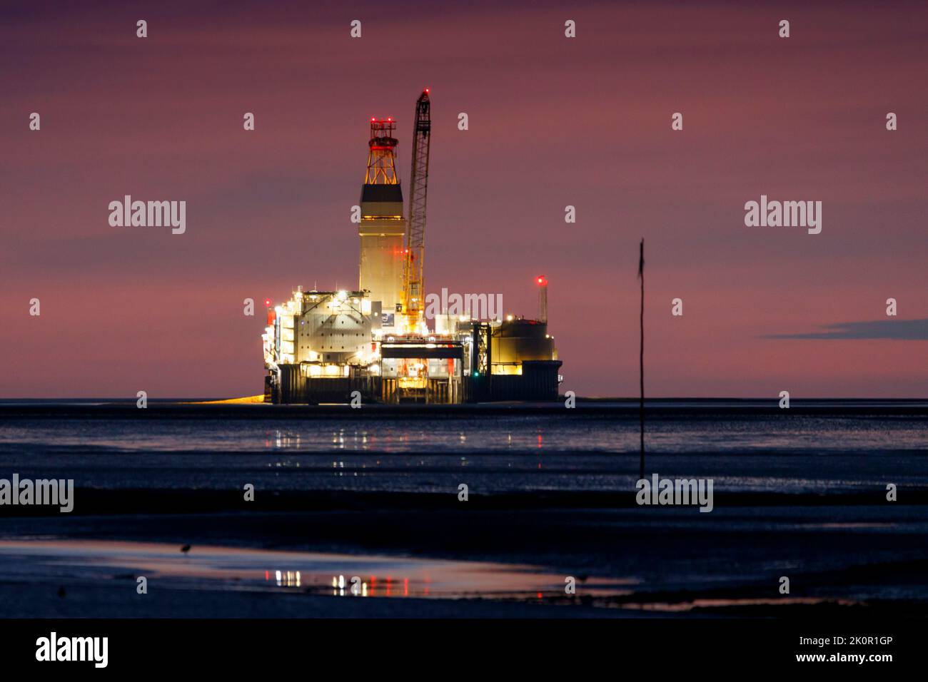 Germany's only oil rig "Mittelplate" at night Stock Photo - Alamy