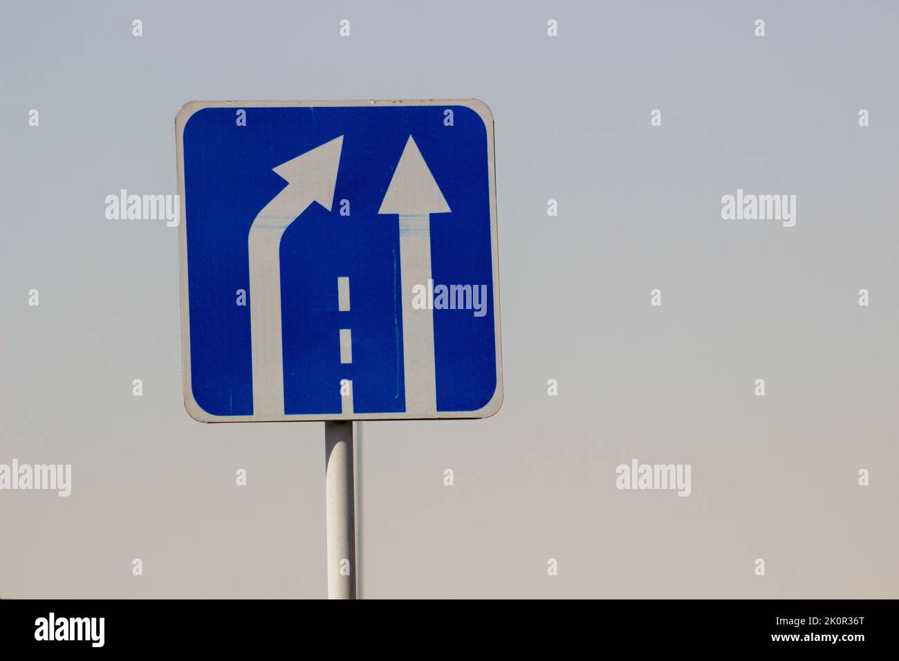 traffic direction sign white arrow on blue background Stock Photo - Alamy