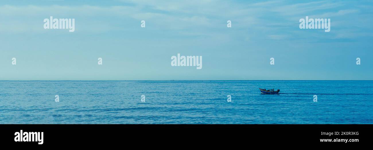 Simple background Calm dark blue sea fishing boat alone white pale ...