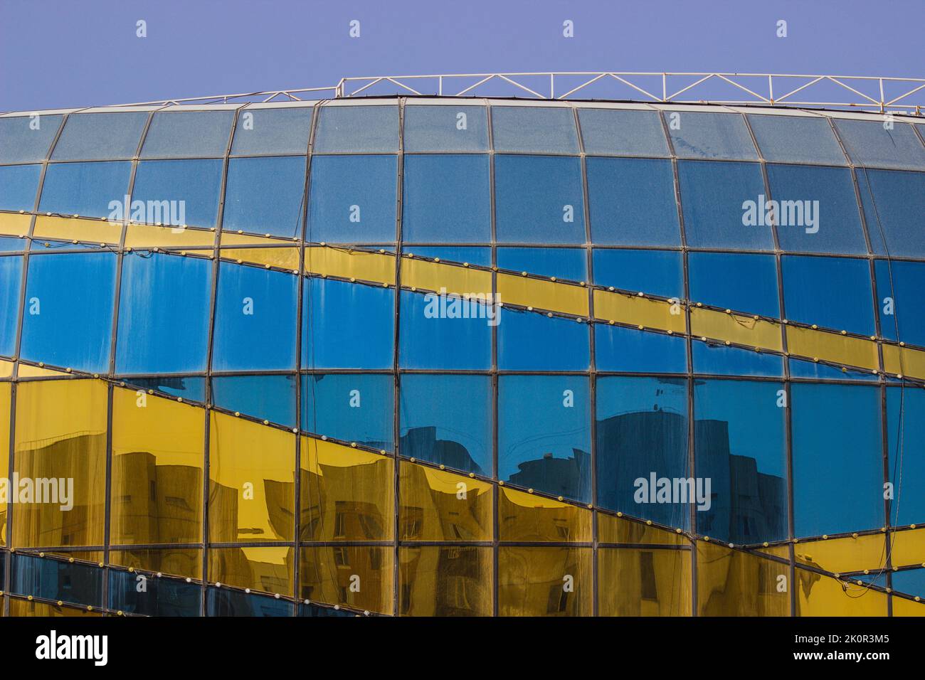 Reflection of modern architecture in windows of stadium building ...