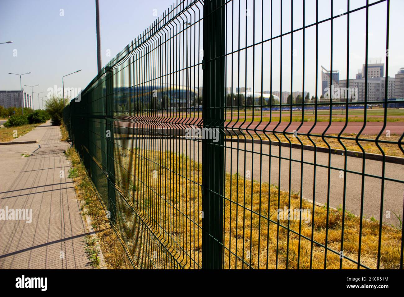 metal fence thin rods city stadium Stock Photo - Alamy