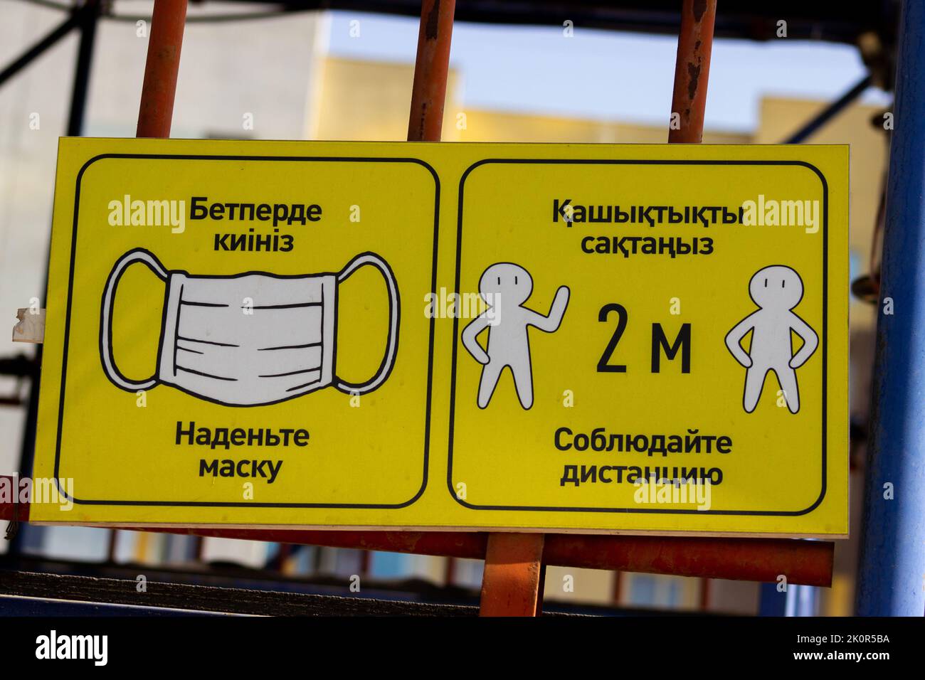 Keep distance wear the mask yellow information sign Stock Photo - Alamy