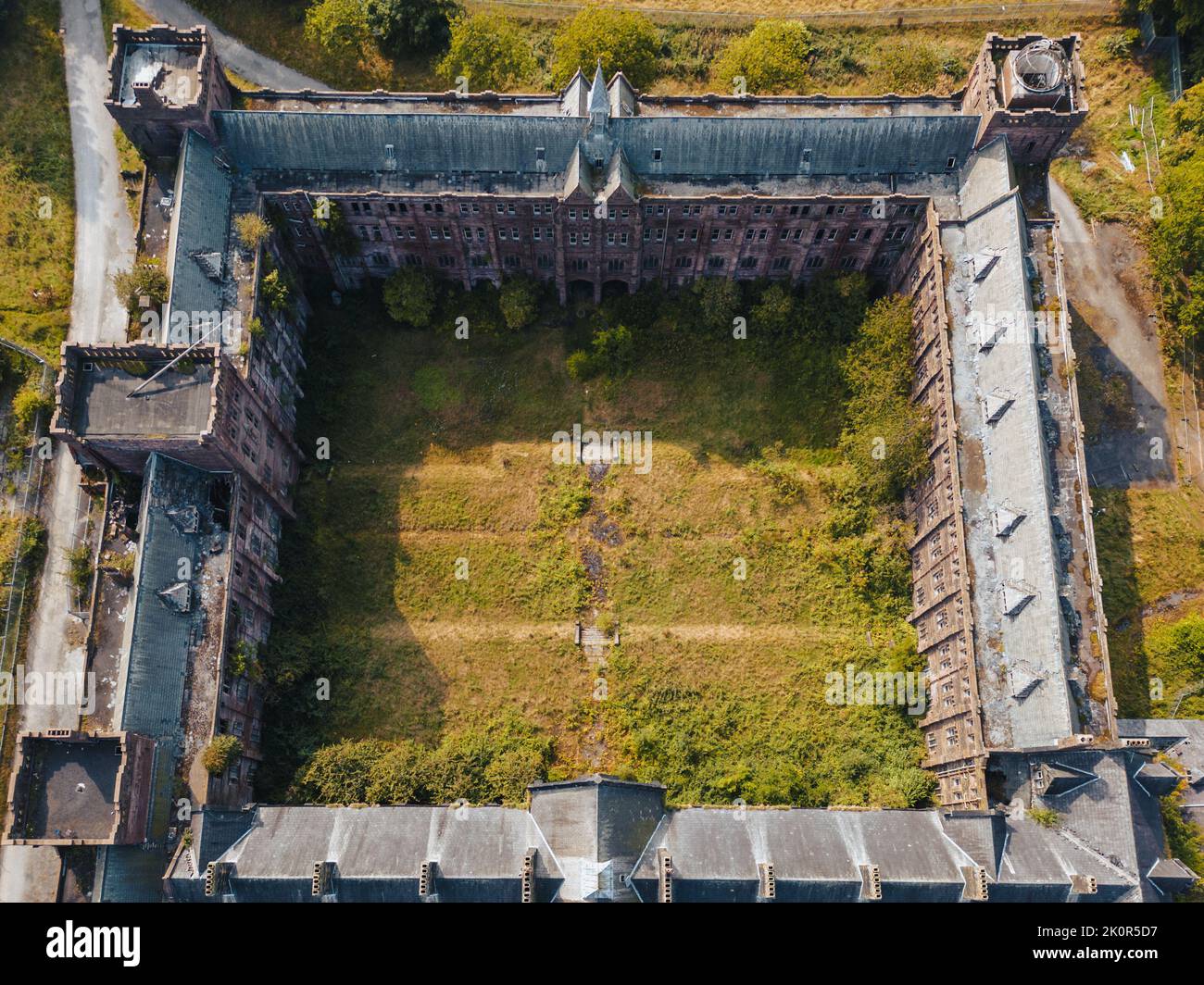Aerial birds eye view of abandoned mansion house and boarding school. A ...