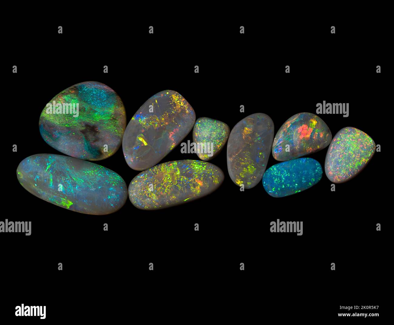 Australian Opal gemstones, shot on a black background to highlight the ...