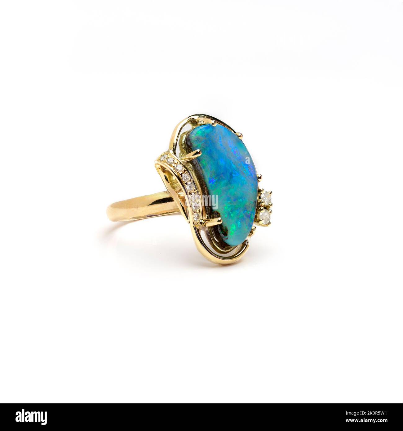Australian Queensland boulder opal set in yellow gold ring displayed on ...