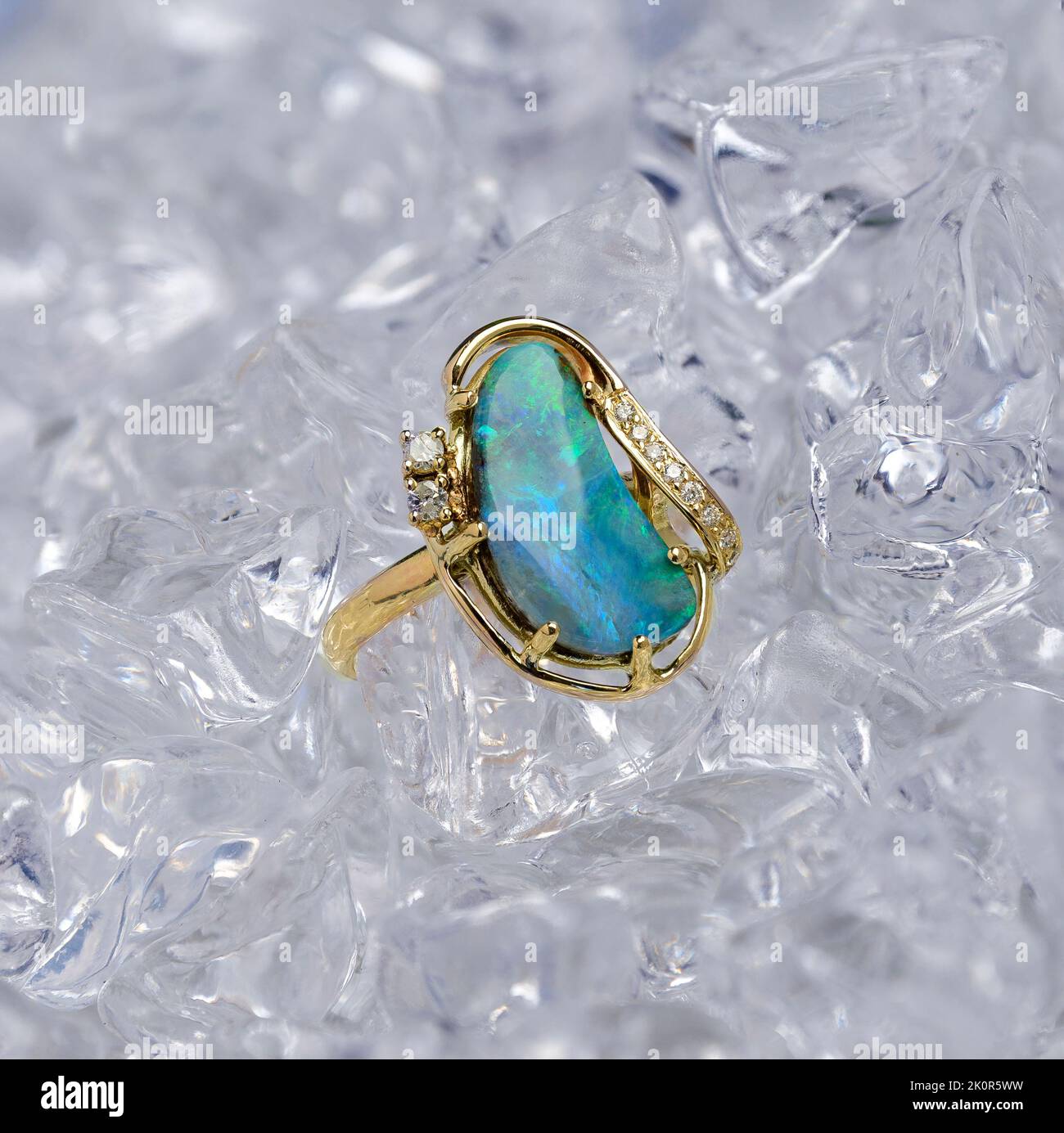Australian Queensland boulder opal set in yellow gold ring displayed on ...