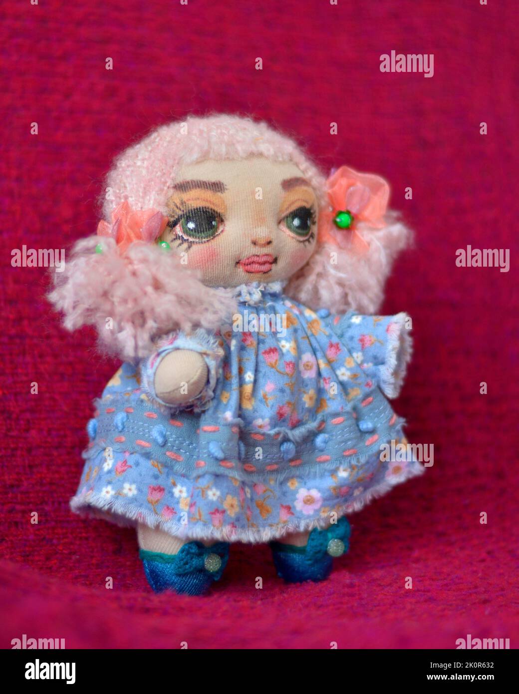 Handmade girl doll in a dress with pink hair and two ponytails Stock ...