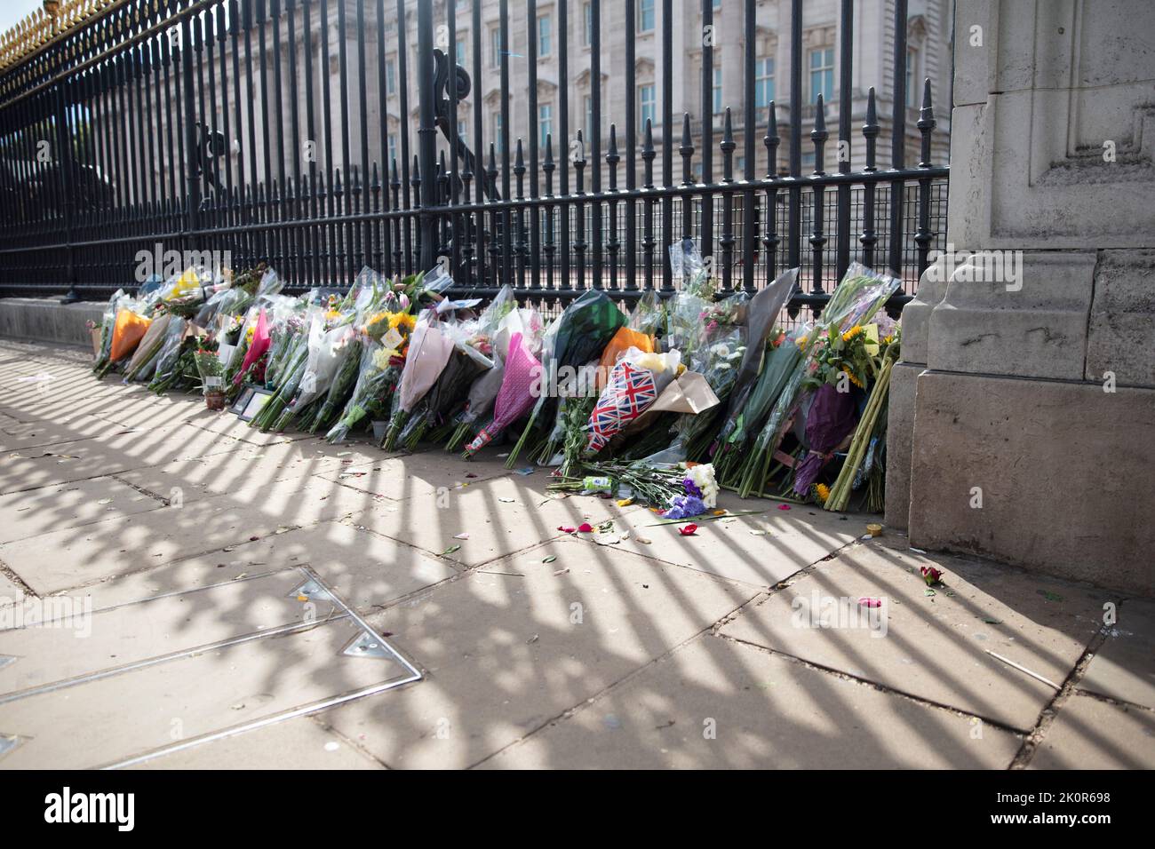 LONDON, UK - September 2022: Flowers are left at the gates of ...