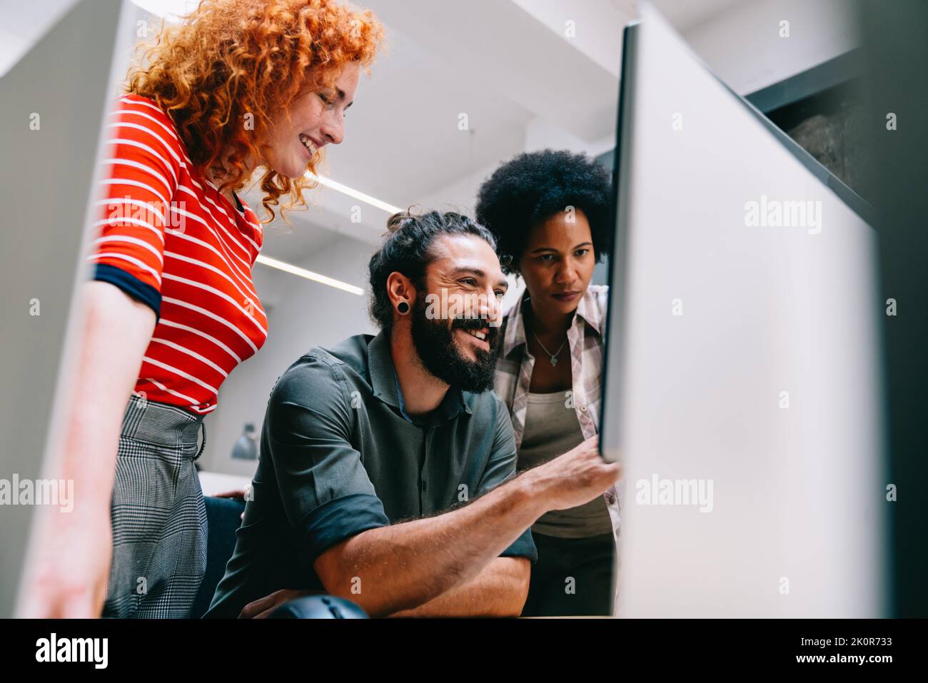 Smiling diverse colleagues gather in boardroom brainstorm discuss ...