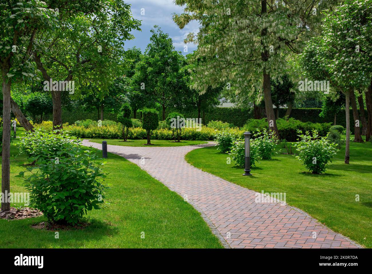 lantern iron ground garden lighting of curved park path paved with ...