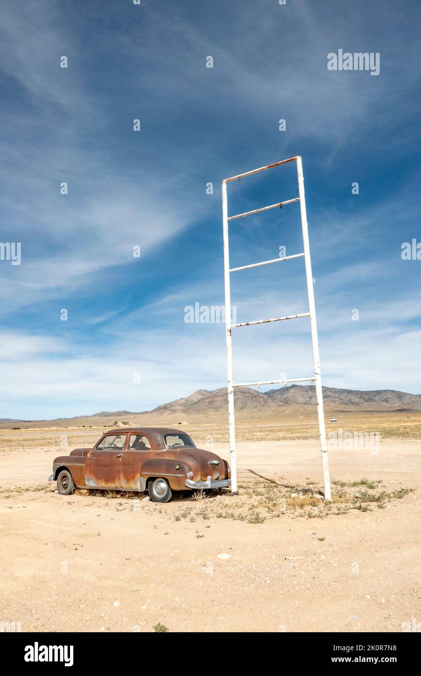 old rotten vintage car at a patrol station in the desert at Route 895 ...