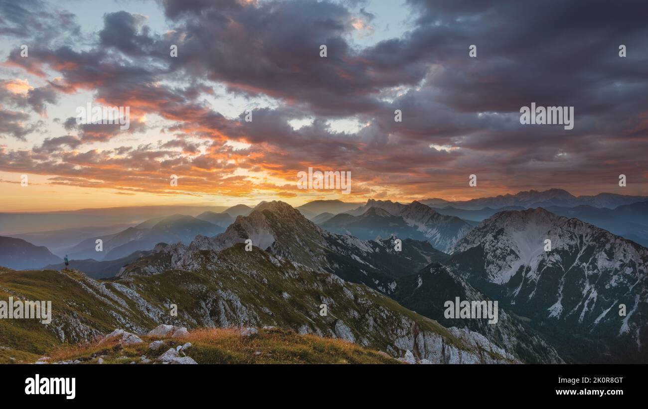 An aerial view of the beautiful mountain chain Karawanks under a pink ...