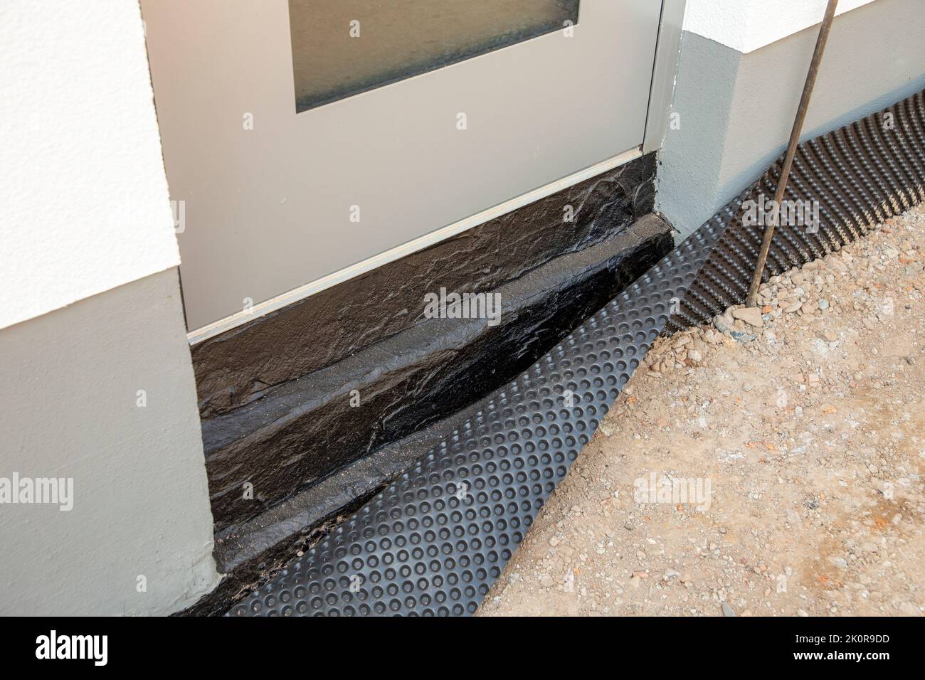 insulation with bitumen at an entrance door at the construction site ...