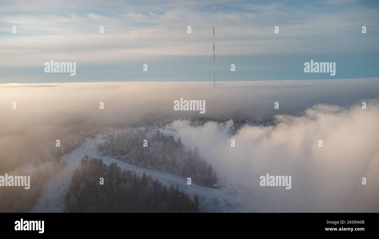 Sunrise breaking through the thick white fog at the top of Vuokatti ...