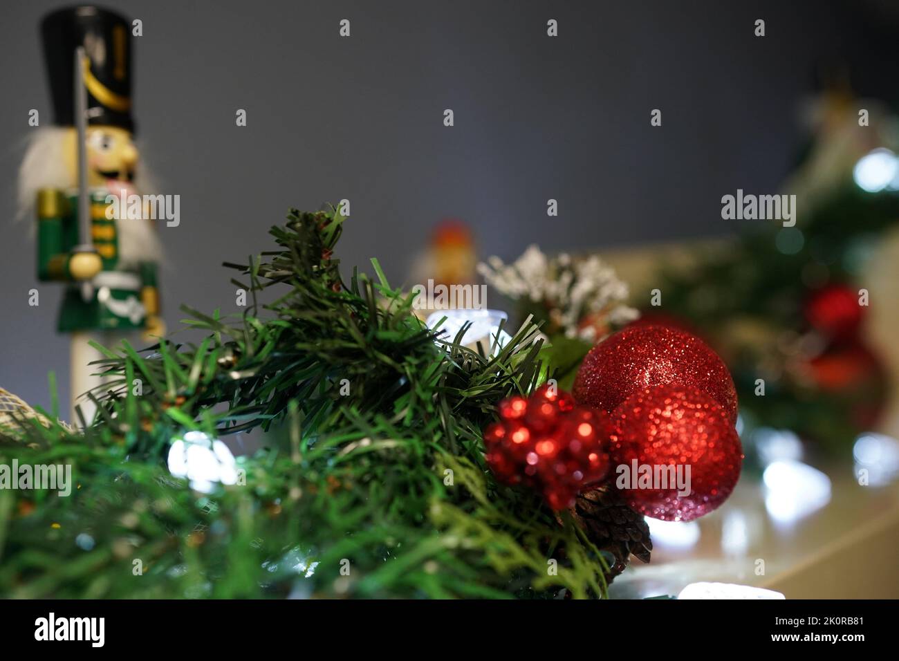A nutcracker toy on top of the Christmas tree with colorful balls Stock ...