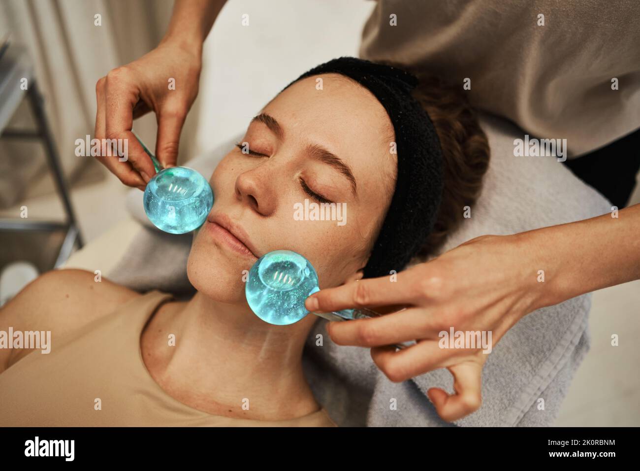 Facial massage with cold spheres Stock Photo - Alamy