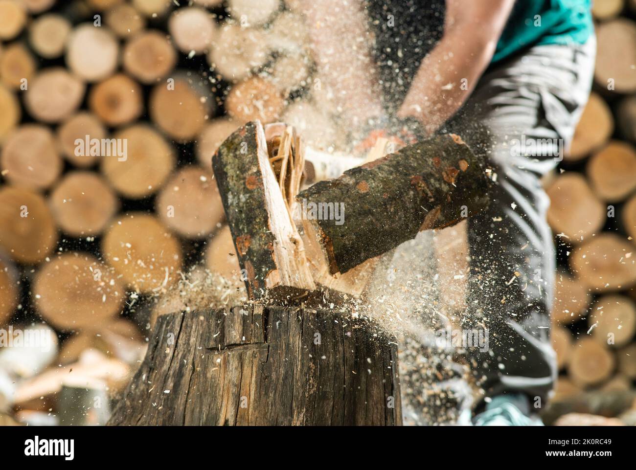 Hand and axe in firewood, chopping wood for fire heat Stock Photo - Alamy