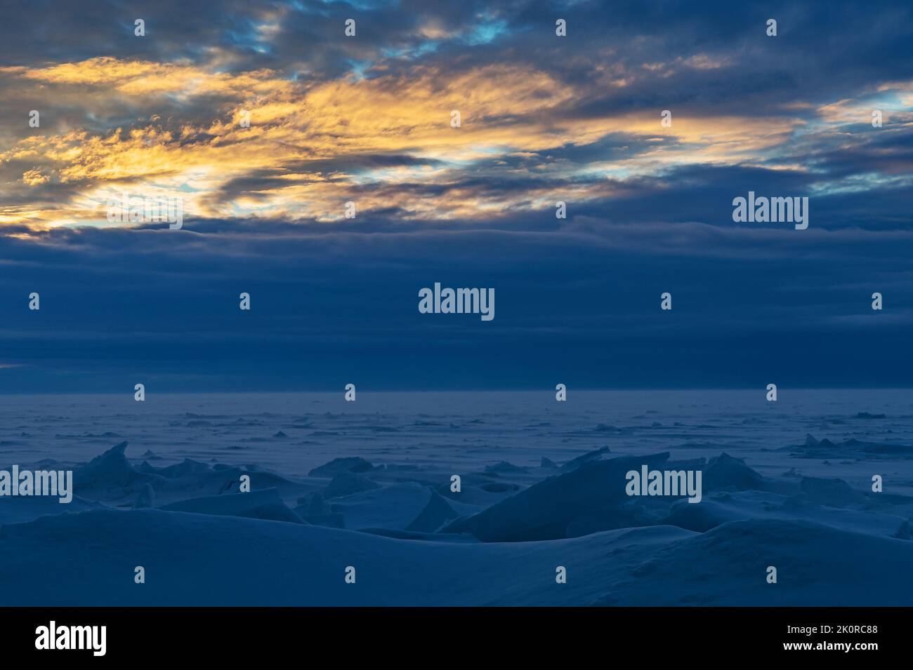 The sun sets into the clouds over Green Bay on Lake Michigan, from ...