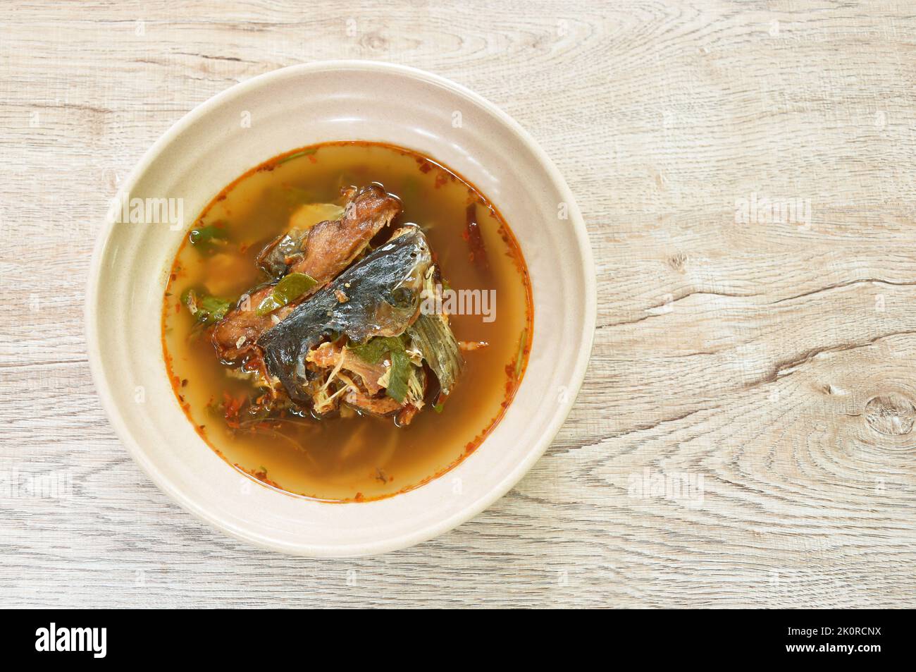 boiled smoked dry snake head fish in spicy and sour soup on bowl Stock ...