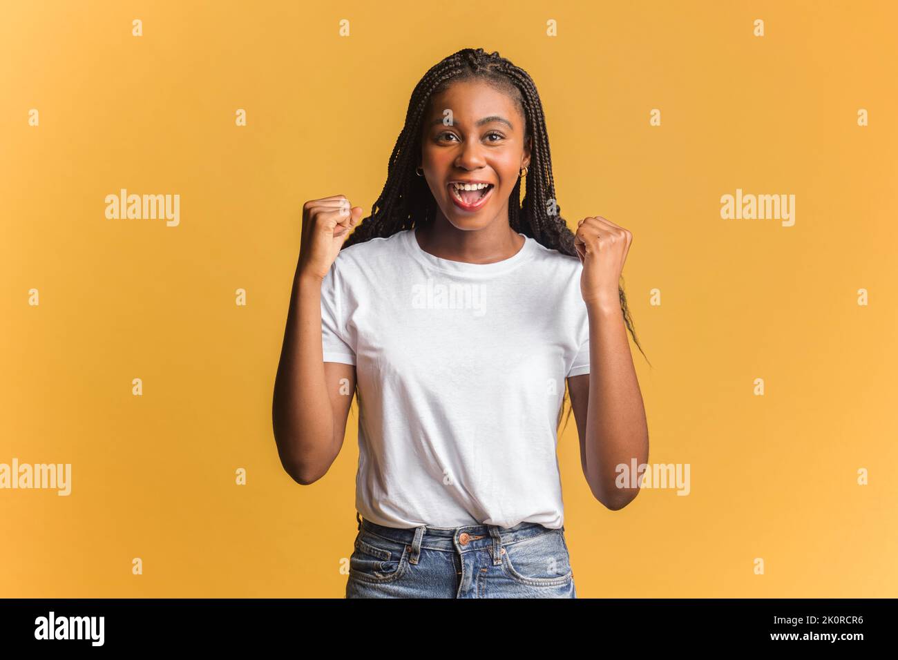 Portrait of excited overjoyed fashionably dressed woman standing with ...