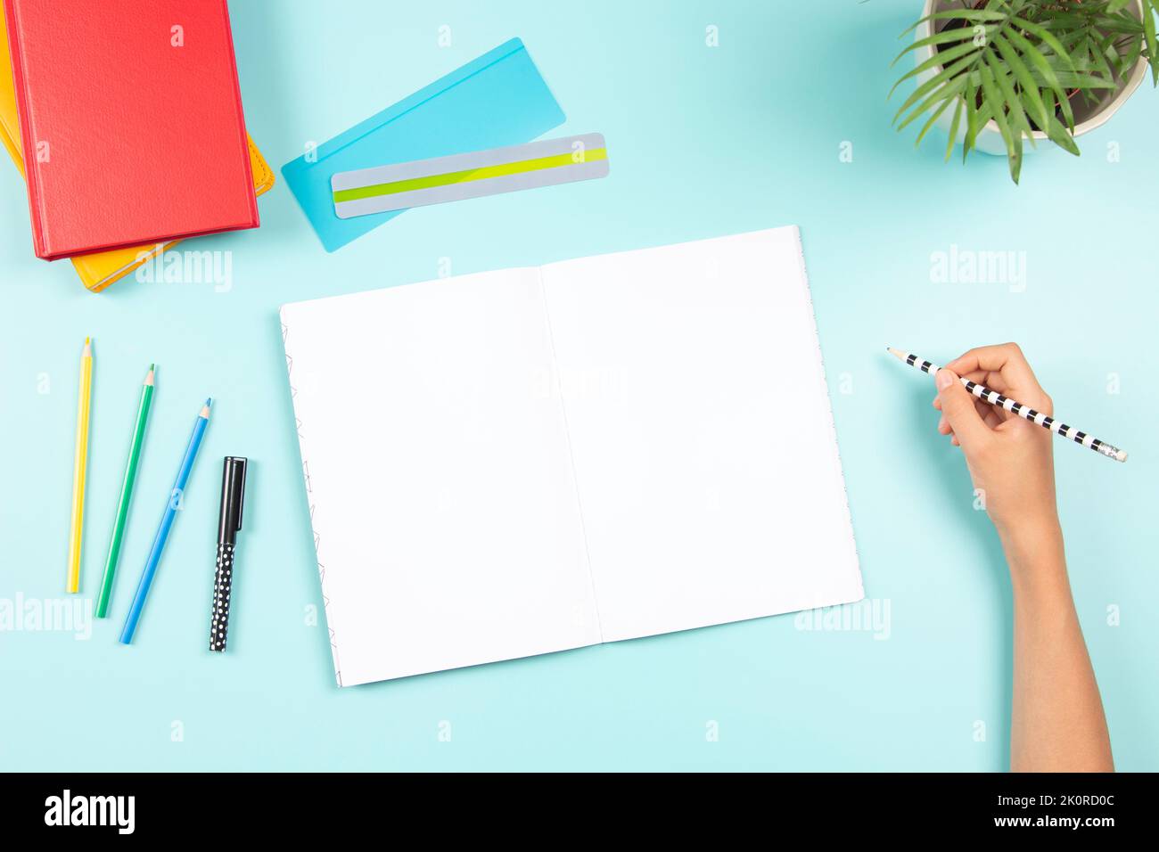 Child doing homework. Top view to desk with open blank notebook, books ...