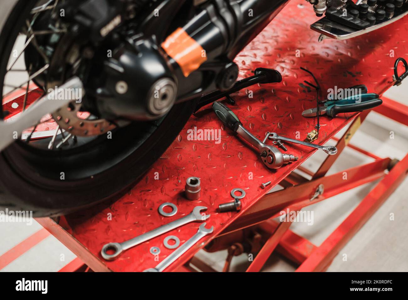 Fixing Custom motorcycle standing in repair shop. Instruments and ...