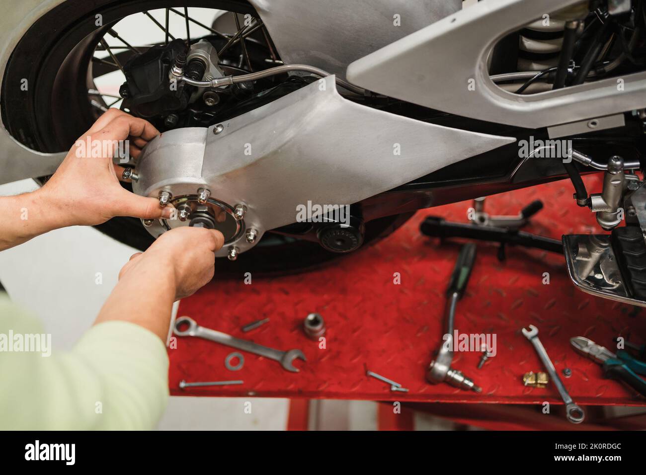 Repairman repair motorcycle, maintenance in garage. Mechanic fixing ...