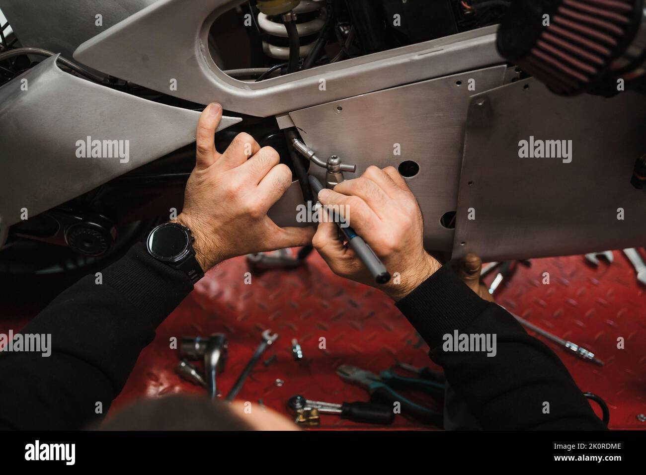 Repairman repair motorcycle, maintenance in garage. Mechanic fixing ...