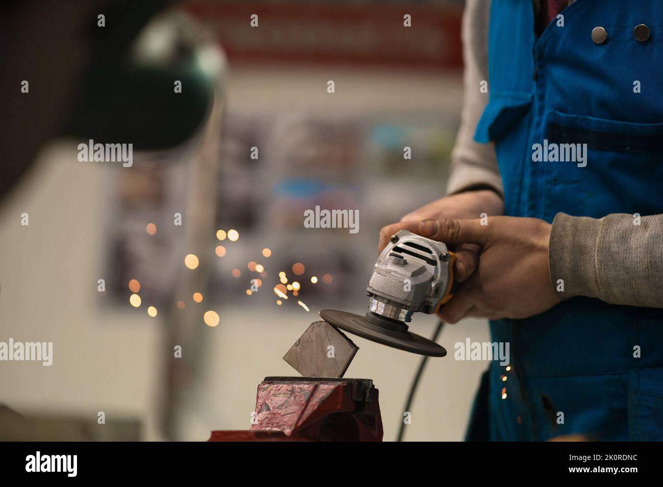 Technician worker cutting metal with many sharp sparks. Using ...