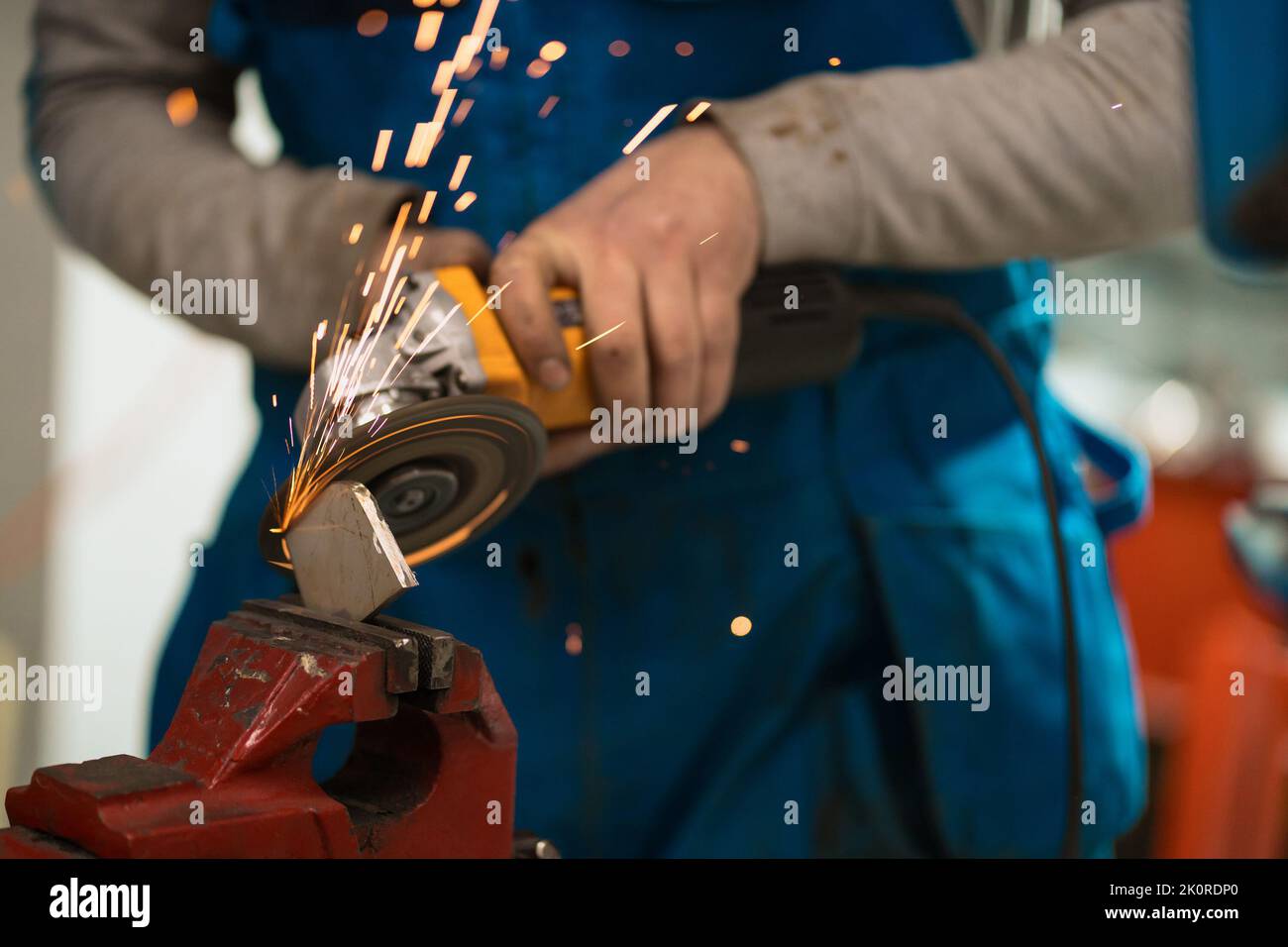 Technician worker cutting metal with many sharp sparks. Using ...
