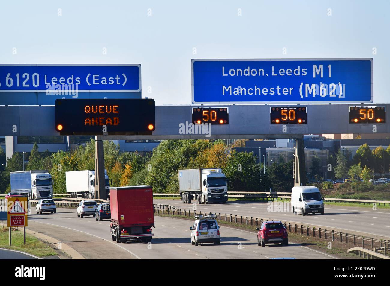 traffic passing flashing warning sign of 50mph reduced speed limit on ... traffic passing flashing warning sign of 50mph reduced speed limit on ...