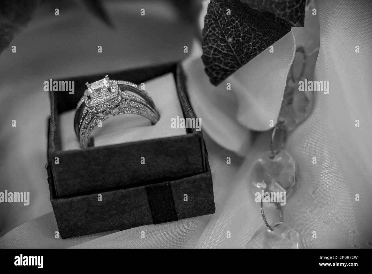 A grayscale closeup of diamond wedding ring in open small box Stock ...