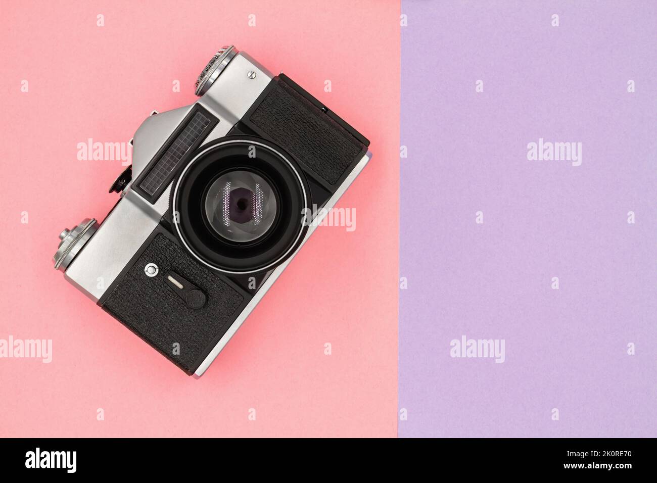Classic vintage black retro camera on a colored background. Top view ...