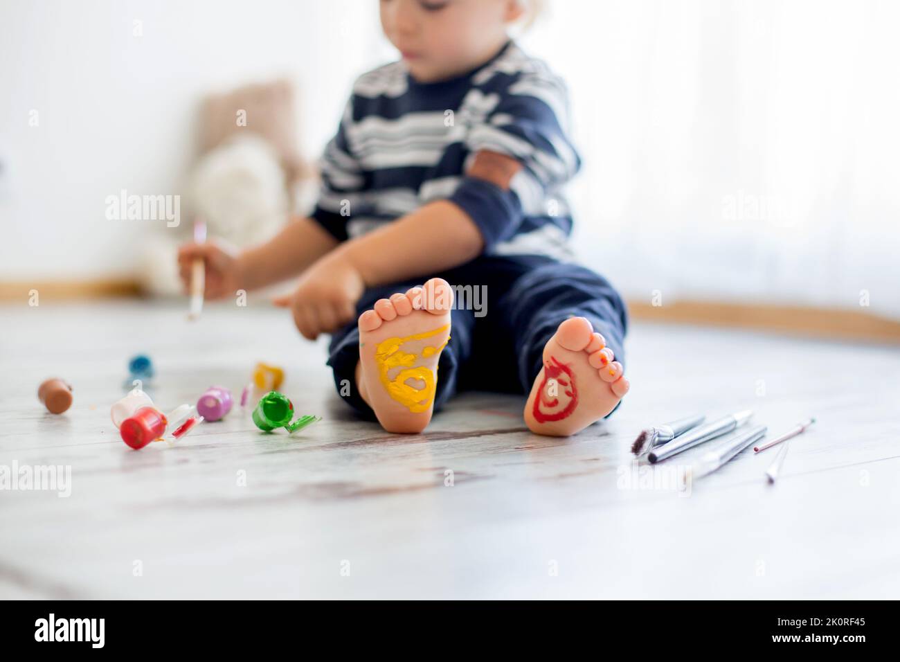 Brothers, playing at home, painting on their feet, tickling, laughing ...