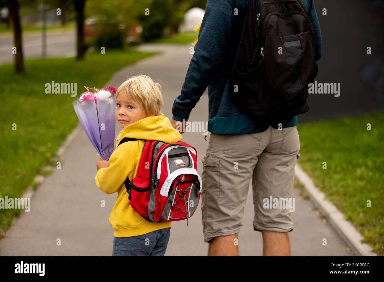 Sad little child,. holding fathers hand, going to school crying, caring ...