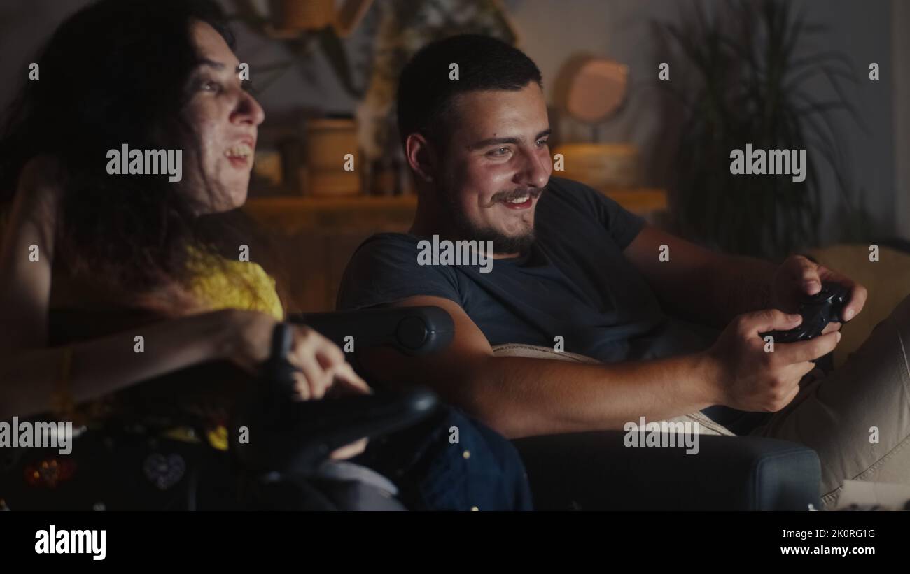 Happy woman with a disability in a wheelchair and man laughing and ...