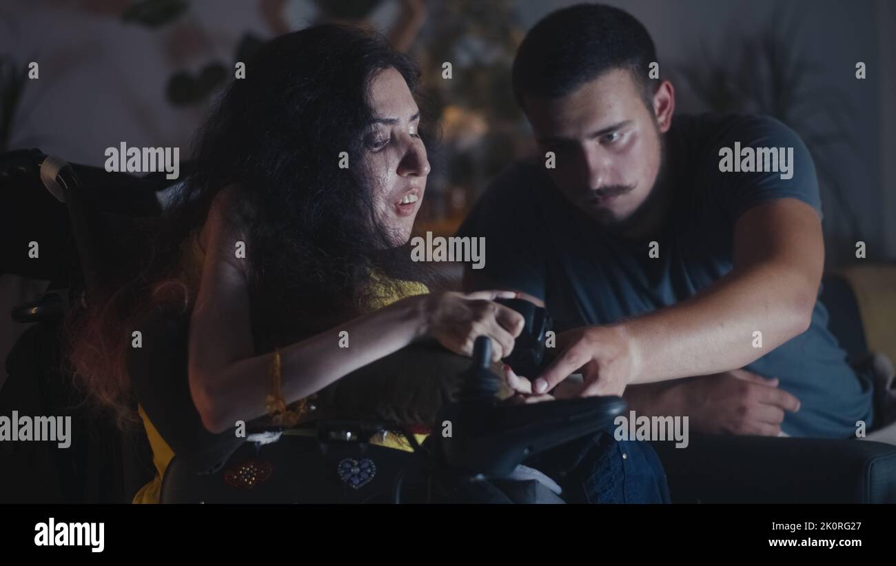 Happy woman with a disability in a wheelchair and man laughing and ...