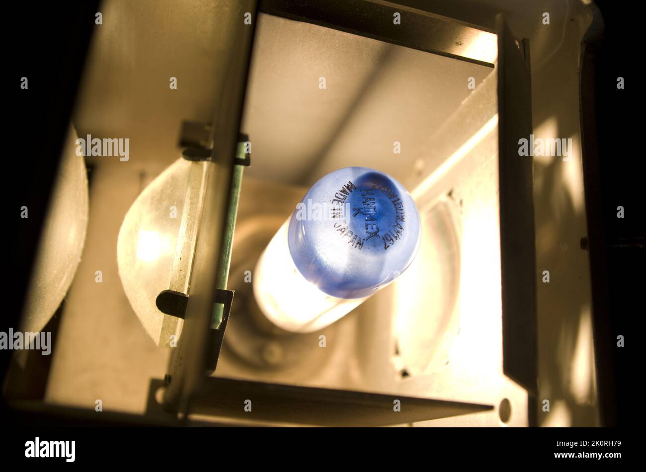 Glowing projector bulb and lenses in retro 1960s Specto slide projector ...