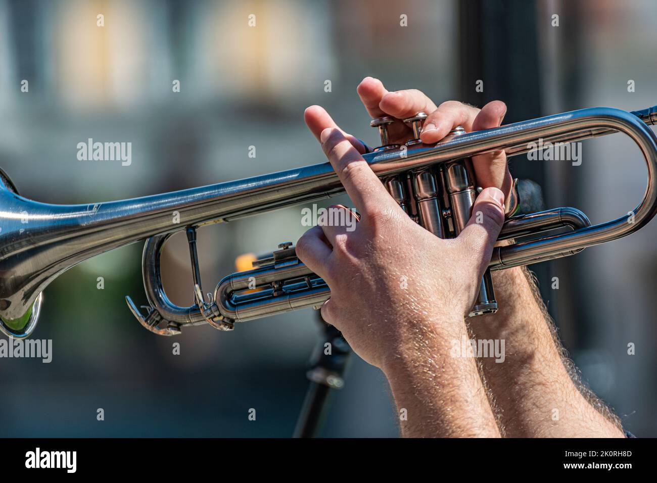 Musical instrument trumpet in hands with fingers on buttons. A young ...
