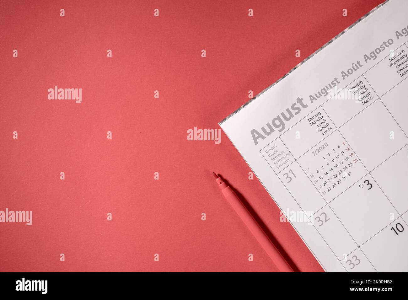 close-up of calendar and red pencil on red table background, business ...
