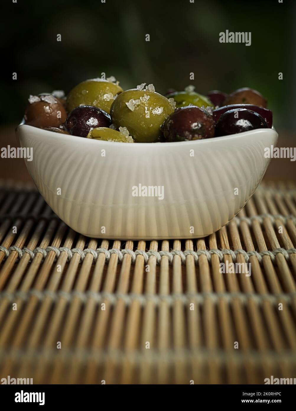 Studio images of side dishes including olives, oil, nuts and peppers ...