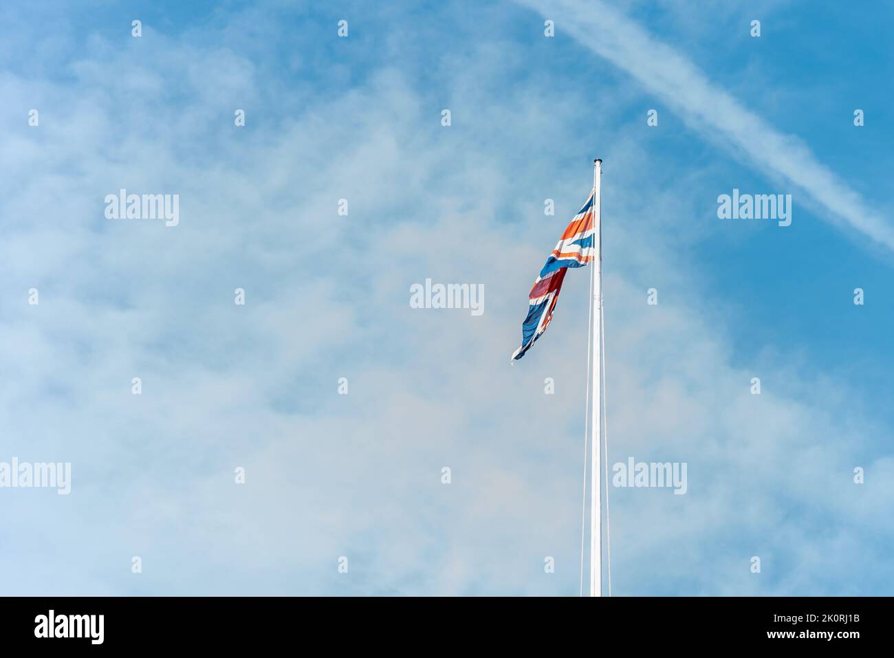 Flag of Great Britain over a light blue sky with some clouds Stock ...