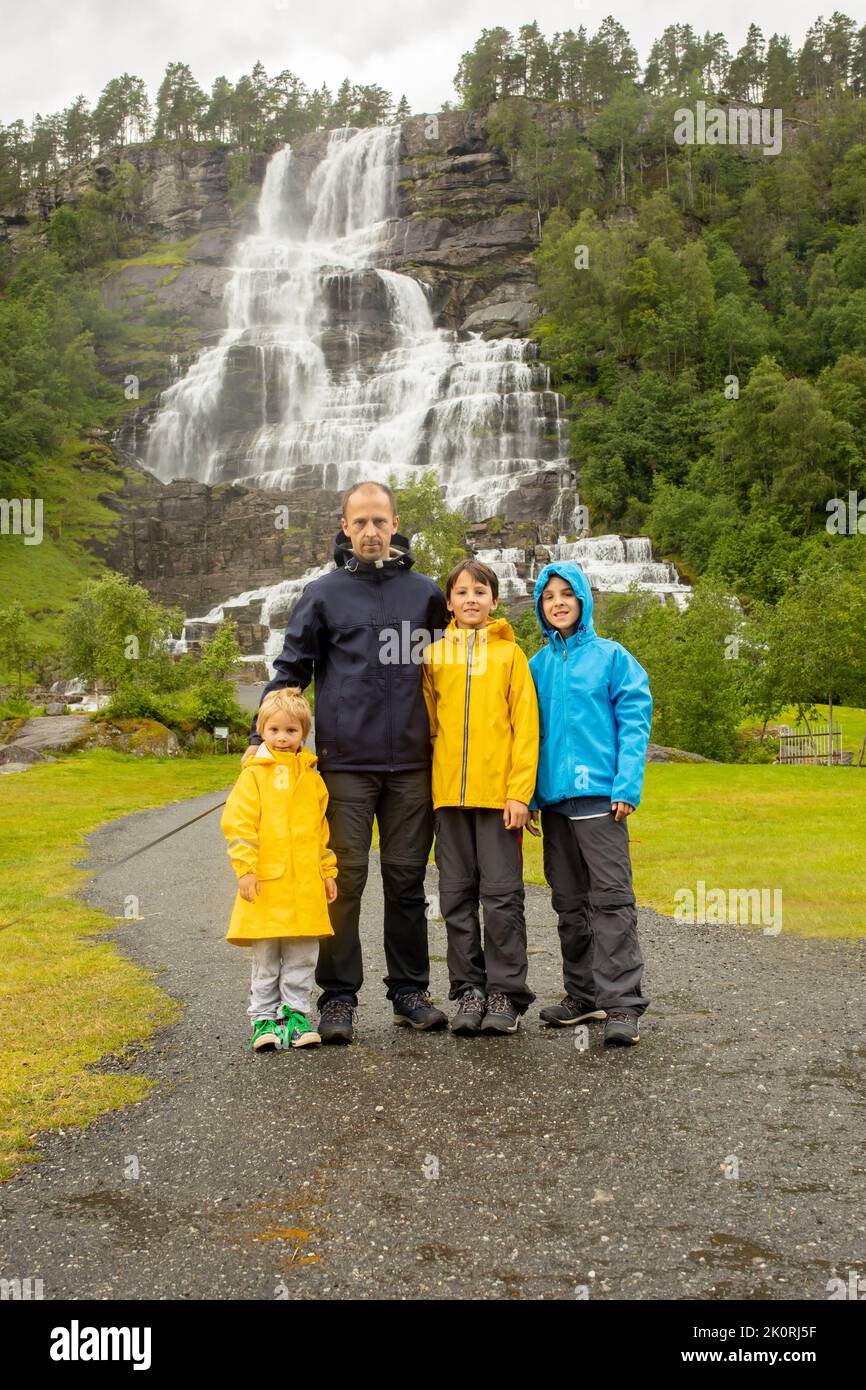 People, visiting Tvinnefossen waterfall, children enjoying the amazing ...