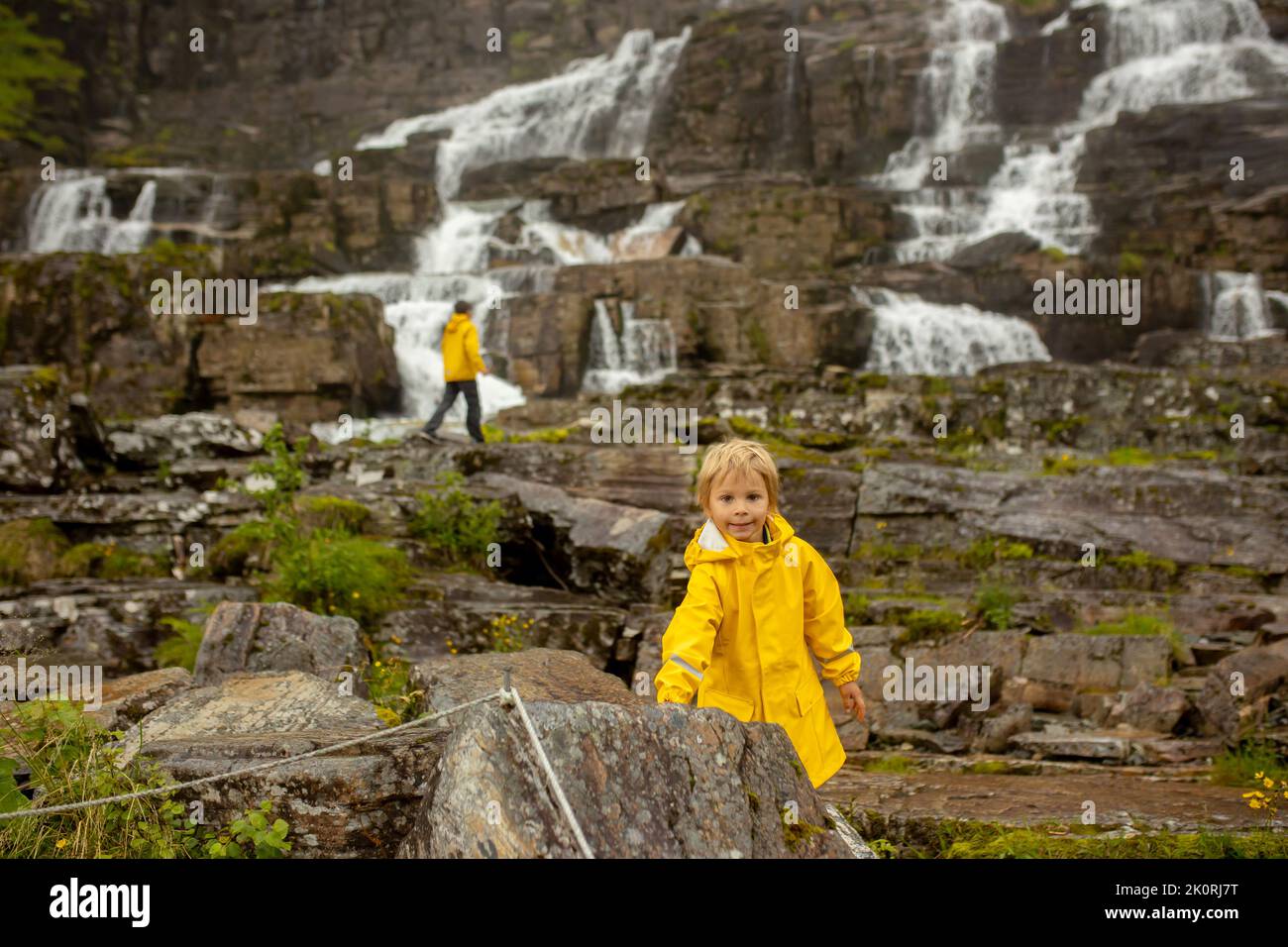 People, visiting Tvinnefossen waterfall, children enjoying the amazing ...