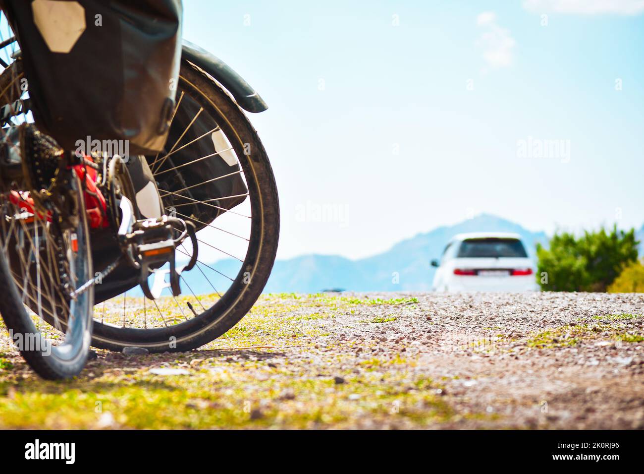 Fully loaded bicycle stand side of road by car pass in nature. Safety ...