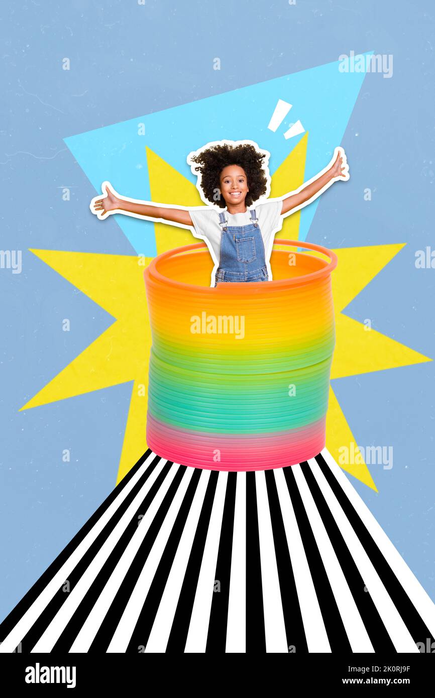 Vertical image of excited cheerful kid stand inside slinky toy raise ...