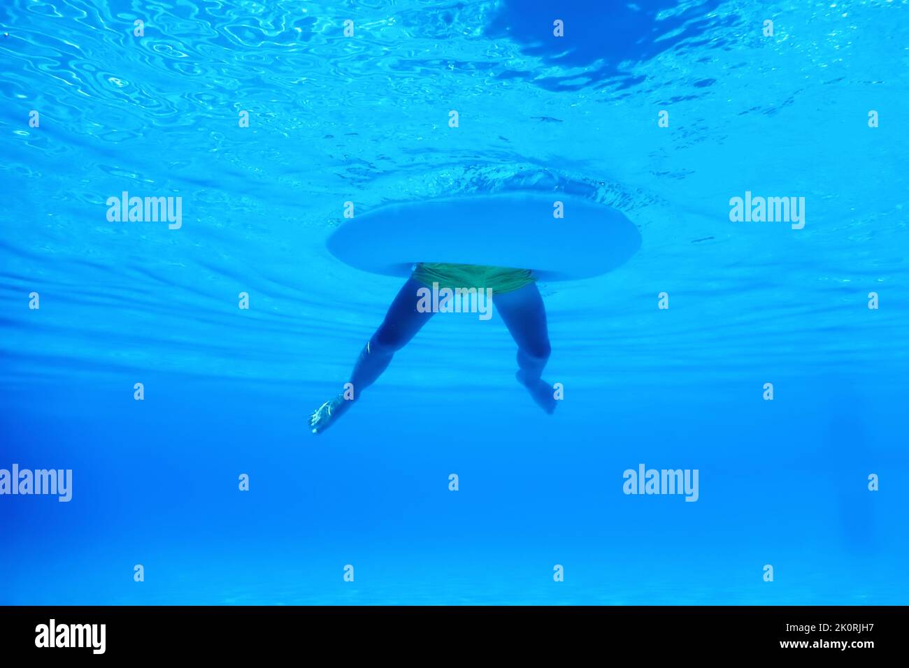 Underwater photo of boy with float swimming in pool Stock Photo - Alamy