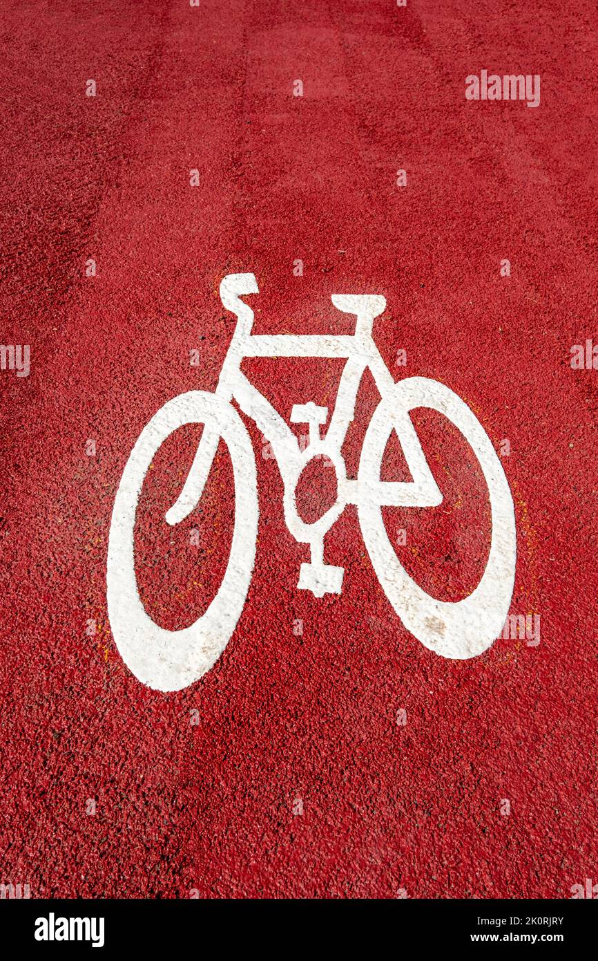 Bicycle symbol painted on red tarmac UK Stock Photo - Alamy