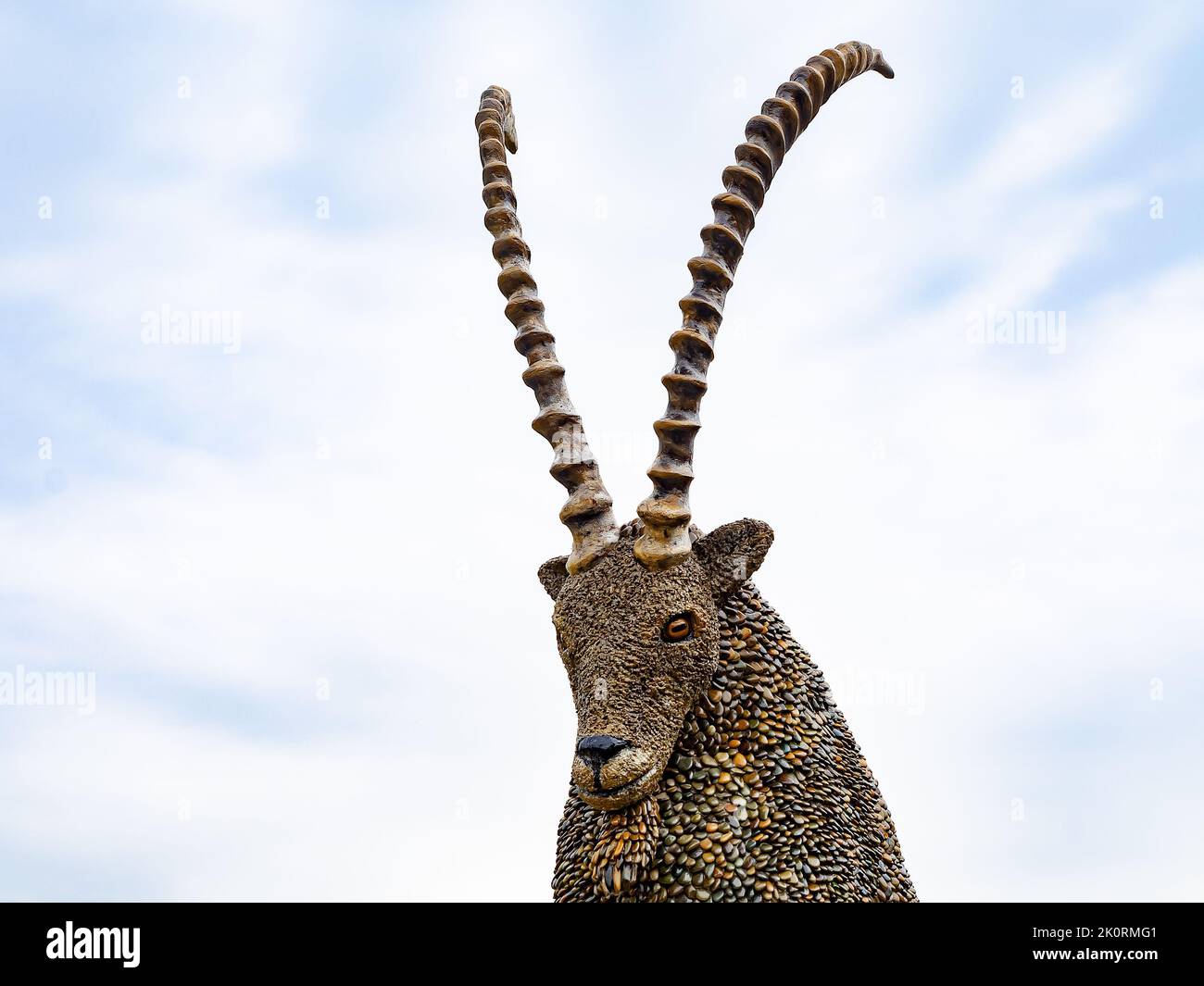 Statue of mountain stone goat. Stone head of caucasian mountain goat ...